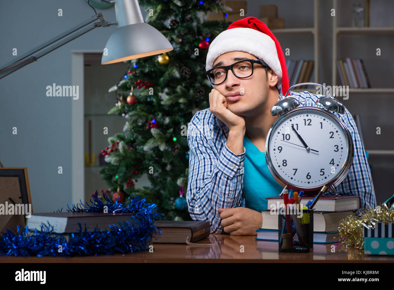 Young man working at home on christmas day Stock Photo - Alamy