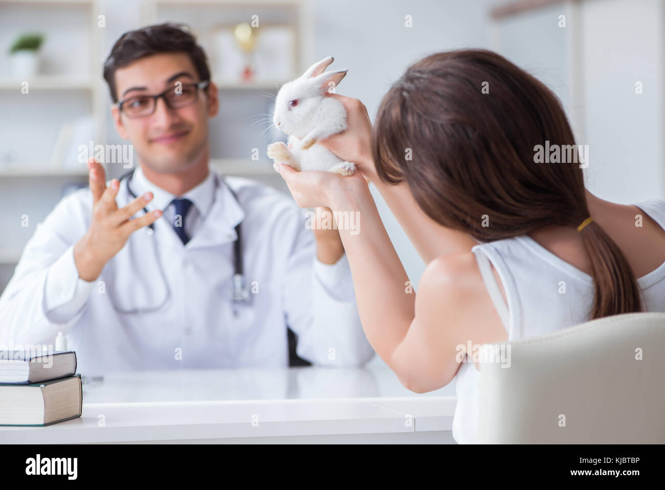 Woman with pet rabbit visiting vet doctor Stock Photo - Alamy