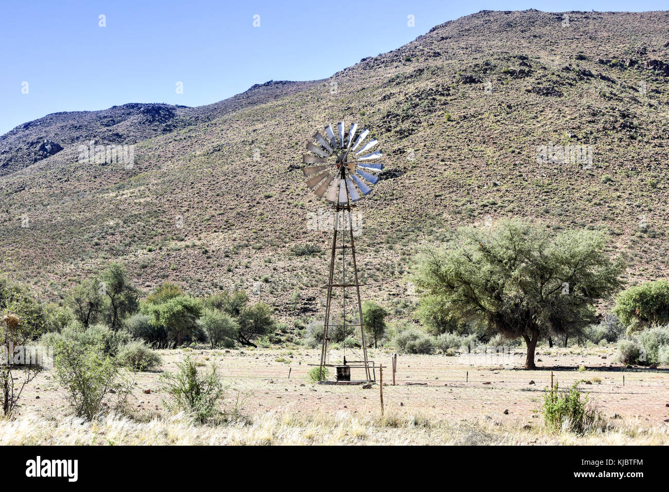 Windmill in the desert landscape of Namibia Stock Photo - Alamy
