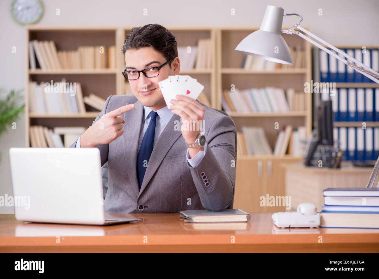 Businessman gambling playing cards at work Stock Photo - Alamy