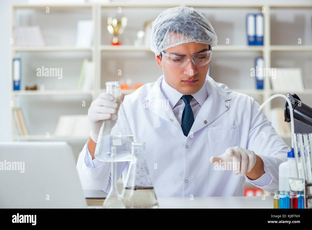 Young researcher scientist doing a water test contamination experiment ...