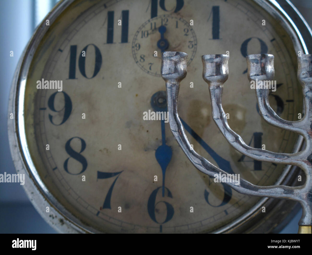 old clock with menorah in front of it Stock Photo - Alamy