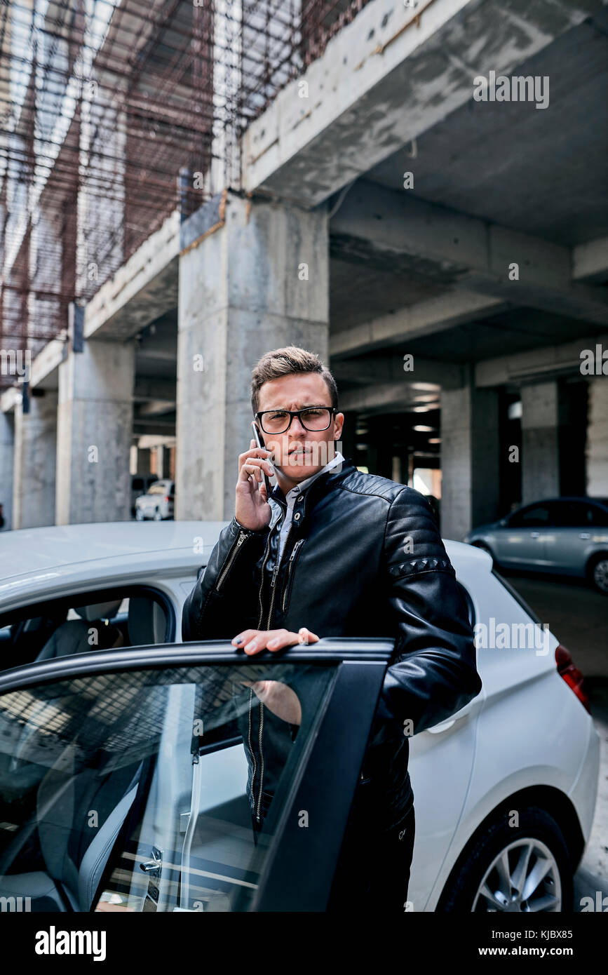 man gets out of the car Stock Photo - Alamy