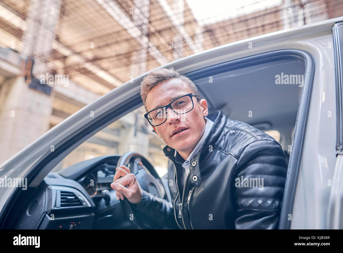 man gets out of the car Stock Photo - Alamy