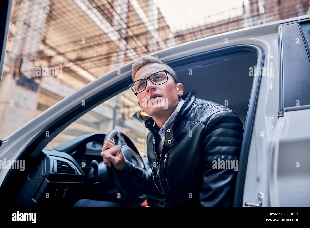 man gets out of the car Stock Photo - Alamy