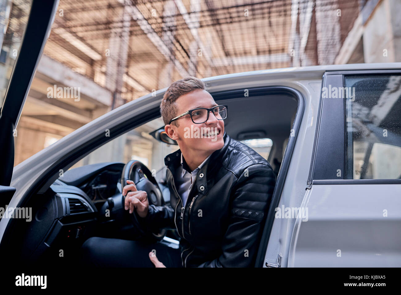 man gets out of the car Stock Photo - Alamy