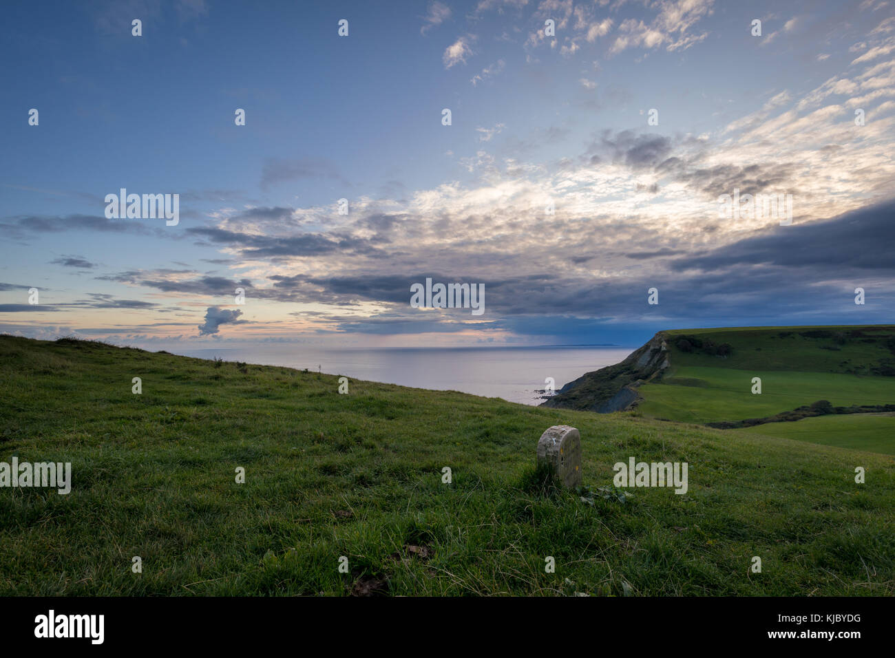 milestone on coastal path at sunset Stock Photo - Alamy