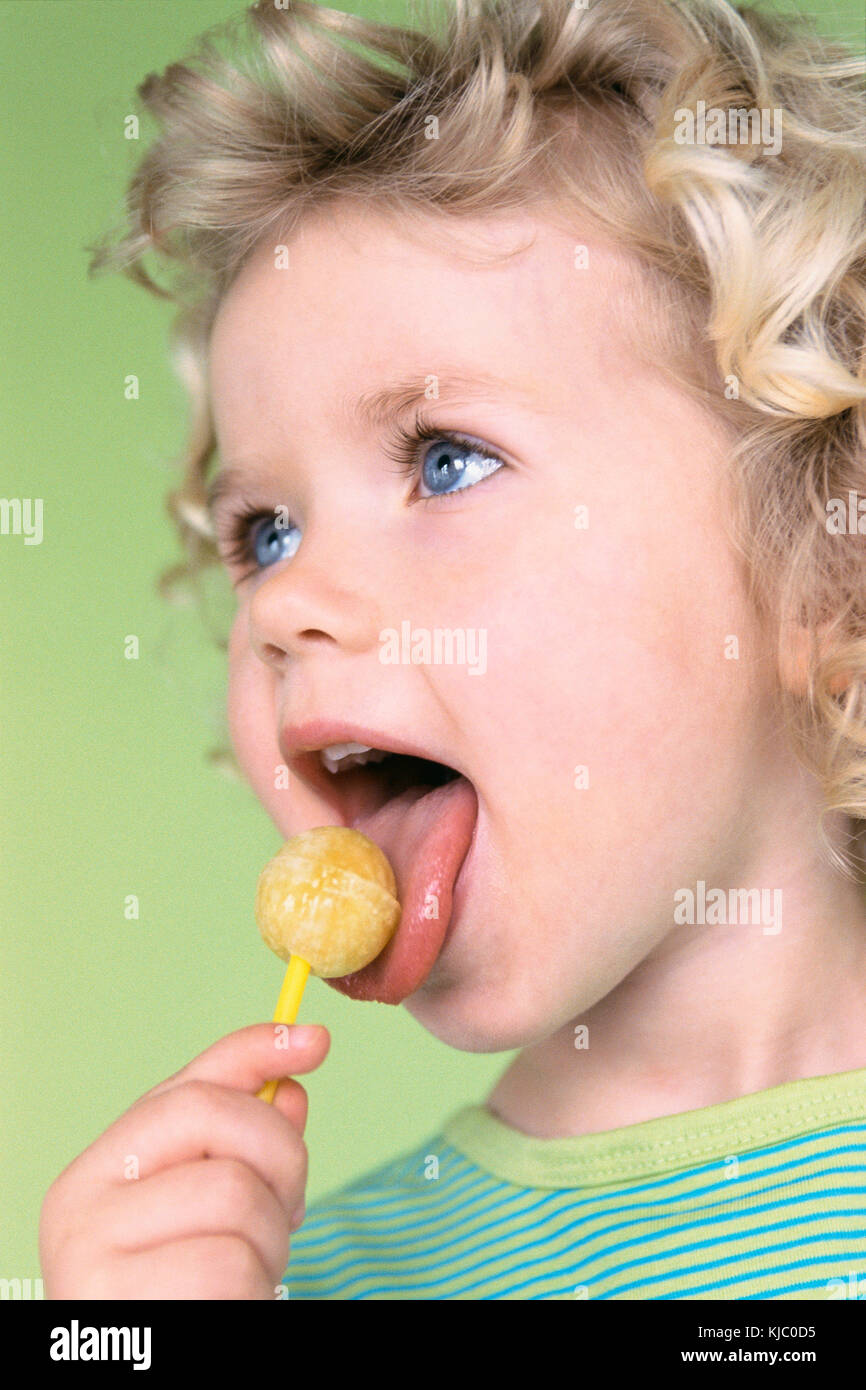 Portrait of Girl Eating Candy Stock Photo - Alamy