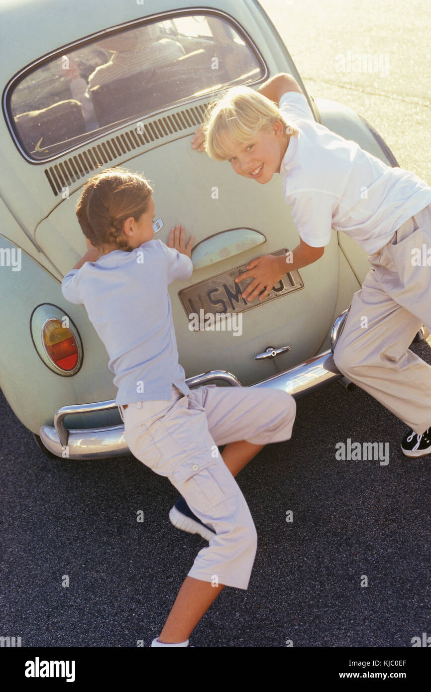 Children Pushing Car Stock Photo - Alamy