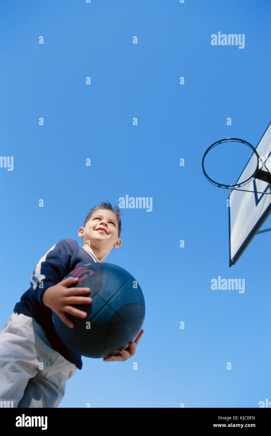 Cool boy holding basketball hi-res stock photography and images - Alamy