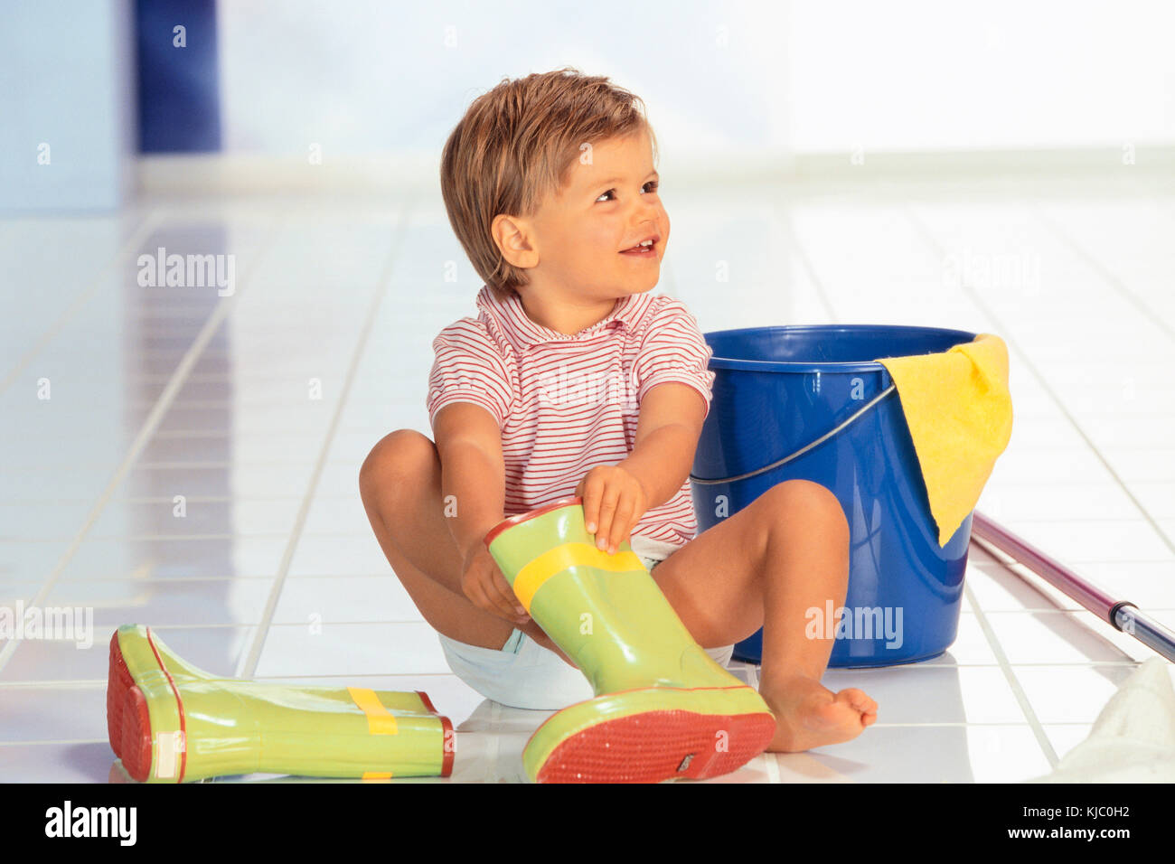 Girl Putting on Boots Stock Photo - Alamy
