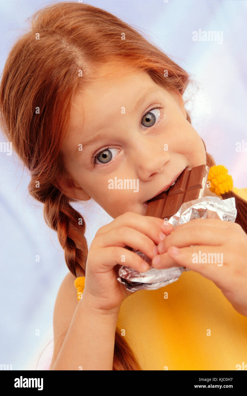 Girl Eating Chocolate Bar Stock Photo - Alamy