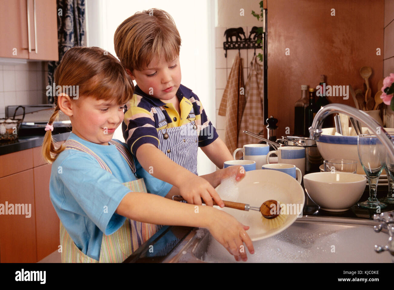 Siblings Doing Dishes Stock Photo - Alamy