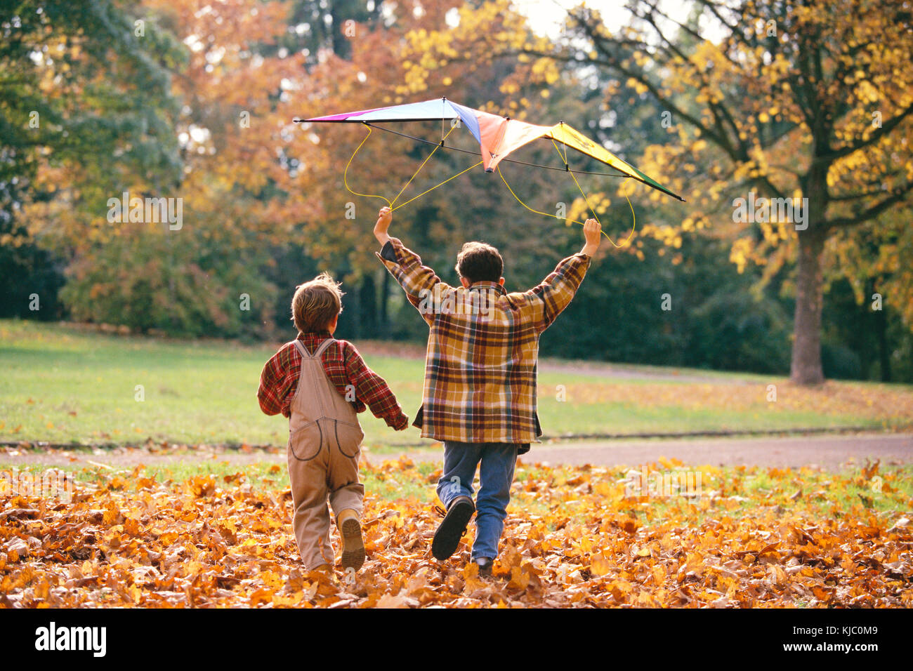Boys Running with Kite Stock Photo - Alamy