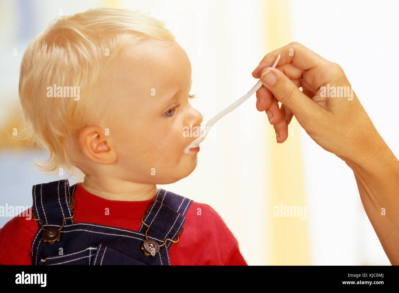 Boy Being Fed Stock Photo - Alamy