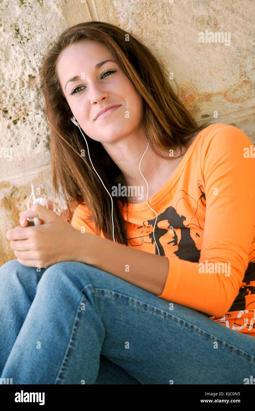 Woman Listening to MP3 Player Stock Photo - Alamy