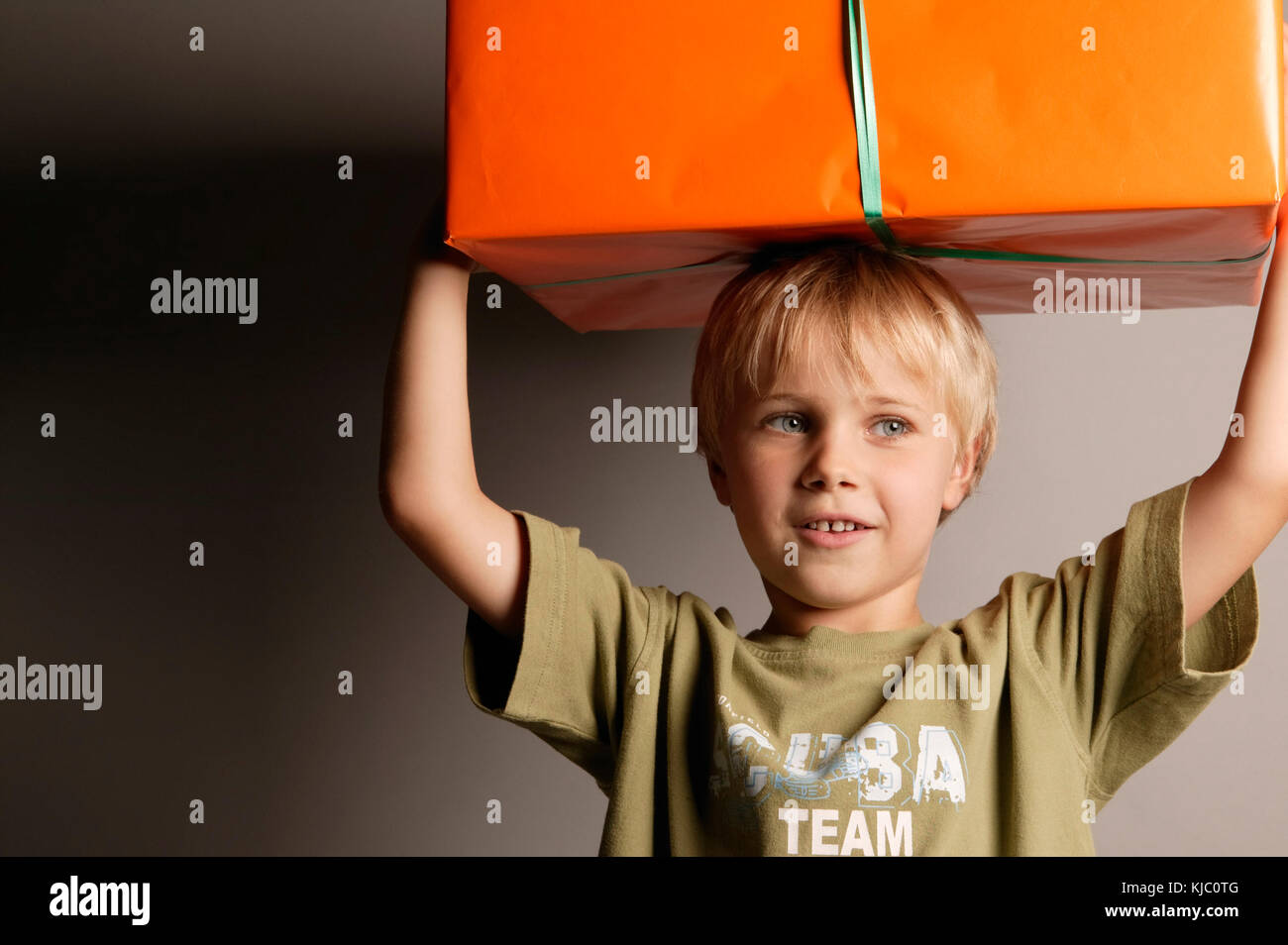 Boy Carrying Package Stock Photo - Alamy