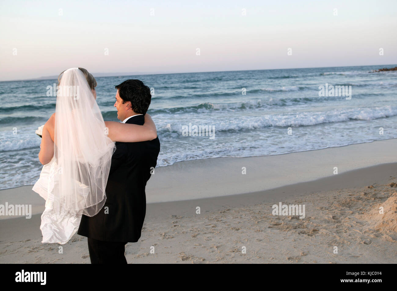 Groom Carrying Bride on Beach, Noosa Beach, Australia Stock Photo - Alamy