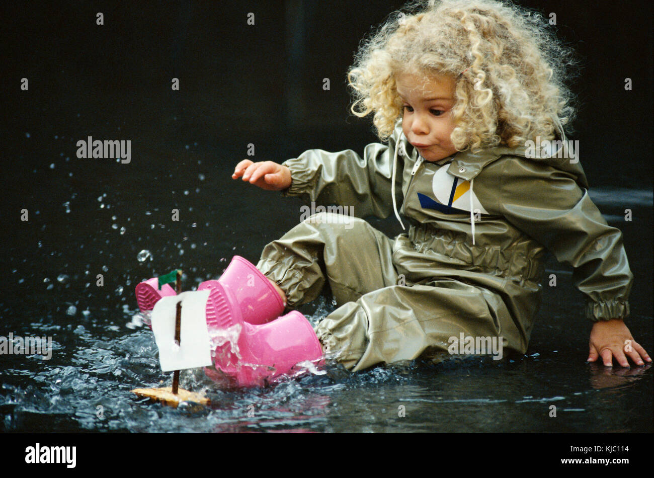 Girl Playing in Puddle Stock Photo - Alamy