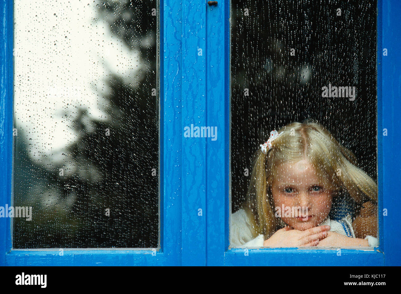 Portrait of Girl in Window Stock Photo - Alamy
