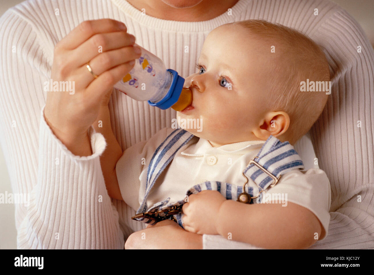 Mother Feeding Baby Stock Photo - Alamy