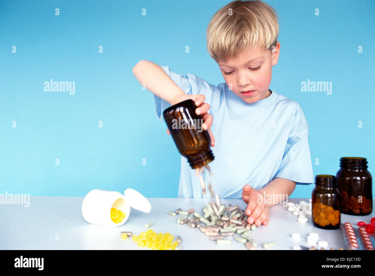 Boy Pouring Medication Stock Photo - Alamy
