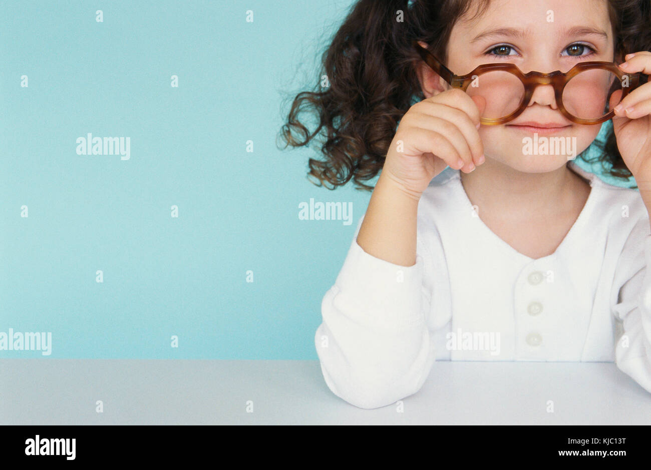 Girl Trying on Glasses Stock Photo - Alamy