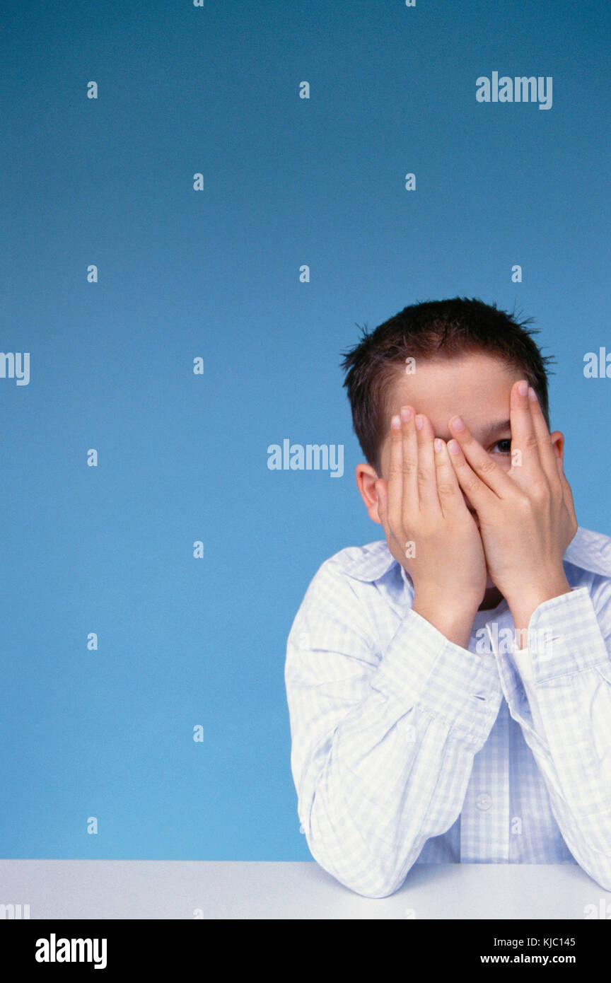 Boy Covering His Face Stock Photo - Alamy