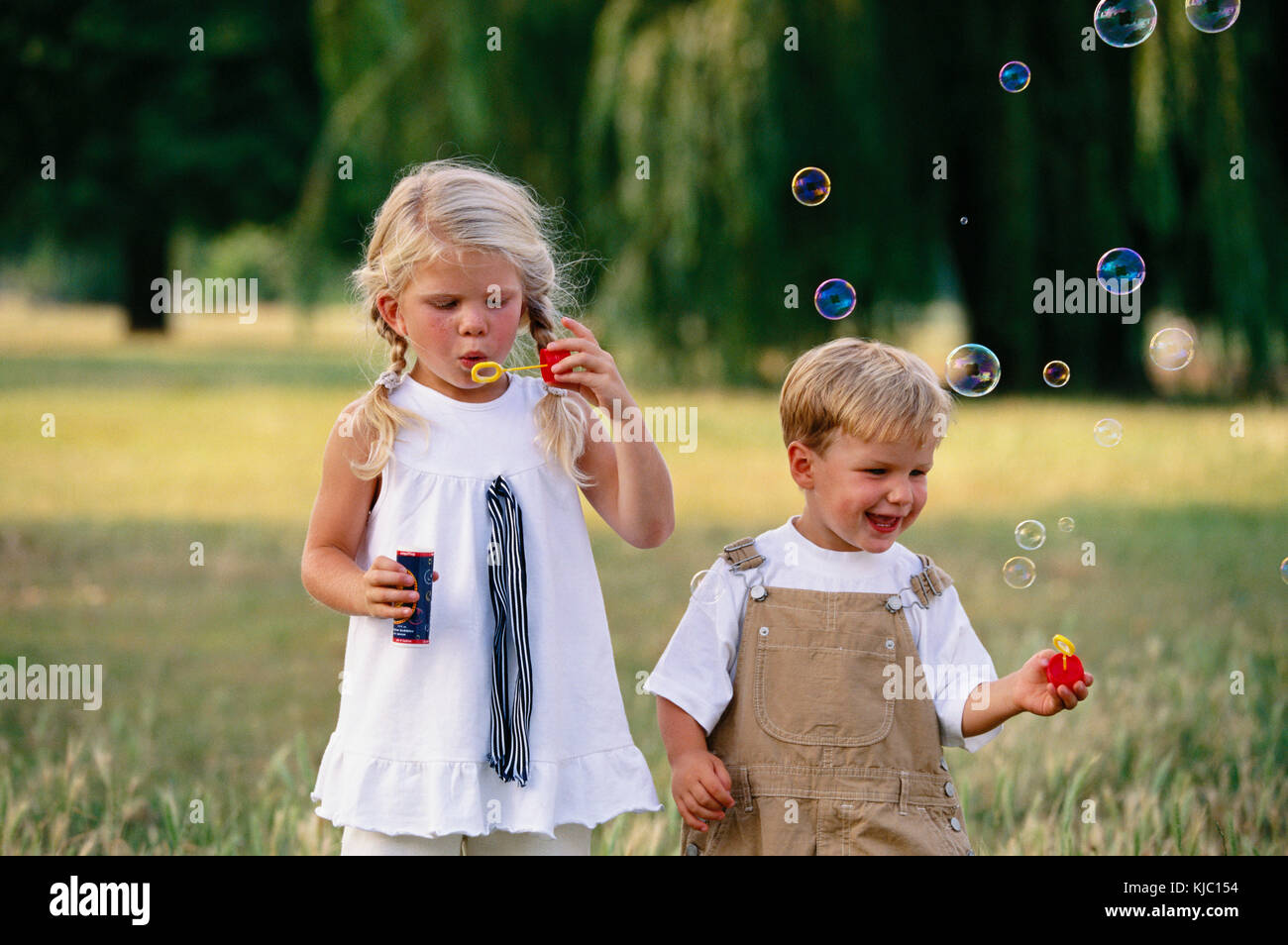 Children Playing With Bubbles Stock Photo - Alamy