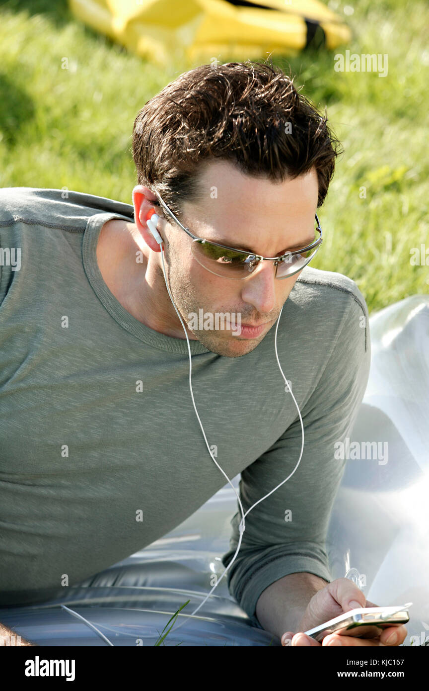 Man Listening to Music on Mp3 Player Stock Photo - Alamy