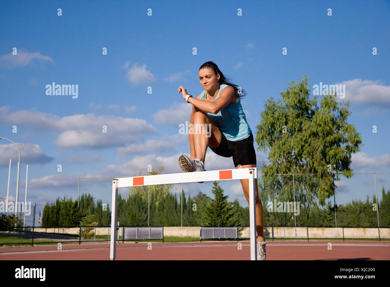 Athlete Jumping Hurdles Stock Photo - Alamy