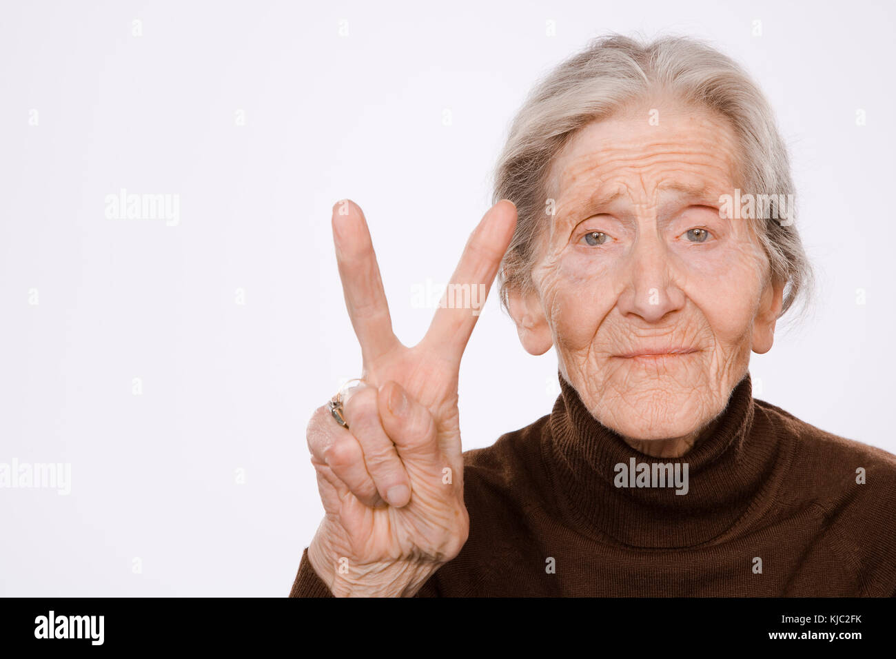 Woman Making Peace Sign Stock Photo - Alamy