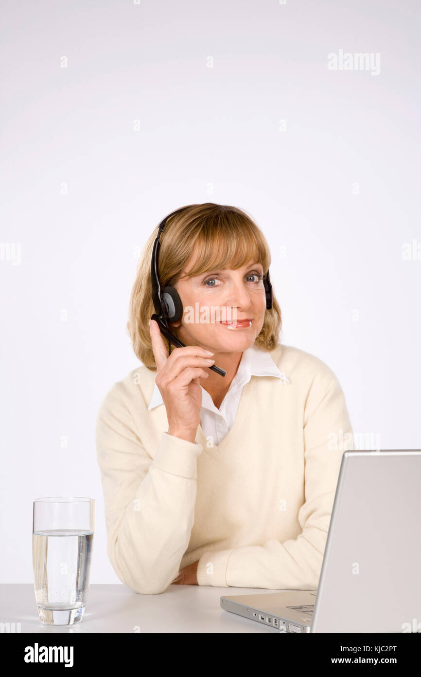 Woman with Headset and Laptop Computer Stock Photo - Alamy