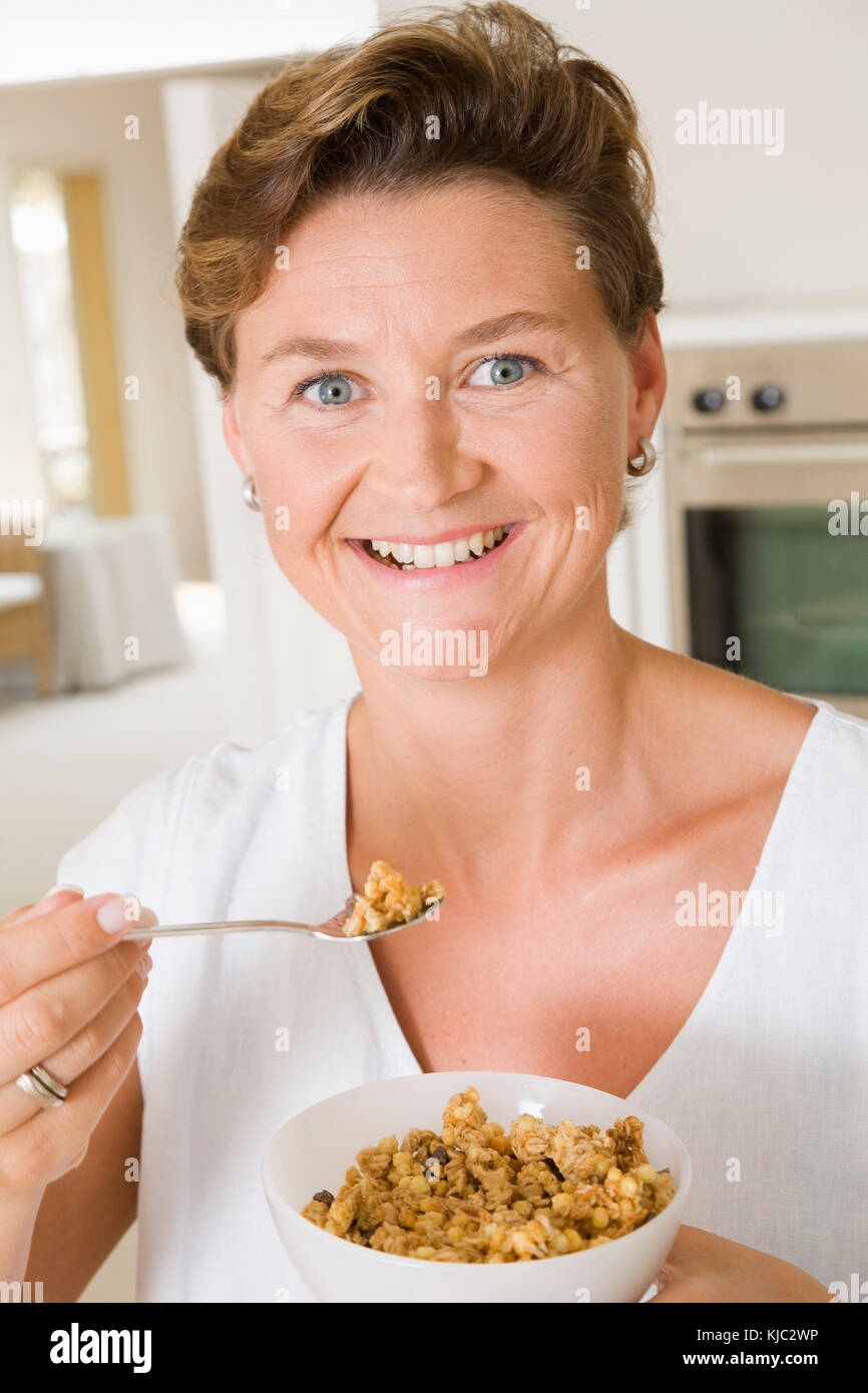 Portrait of Woman Eating Cereal Stock Photo - Alamy