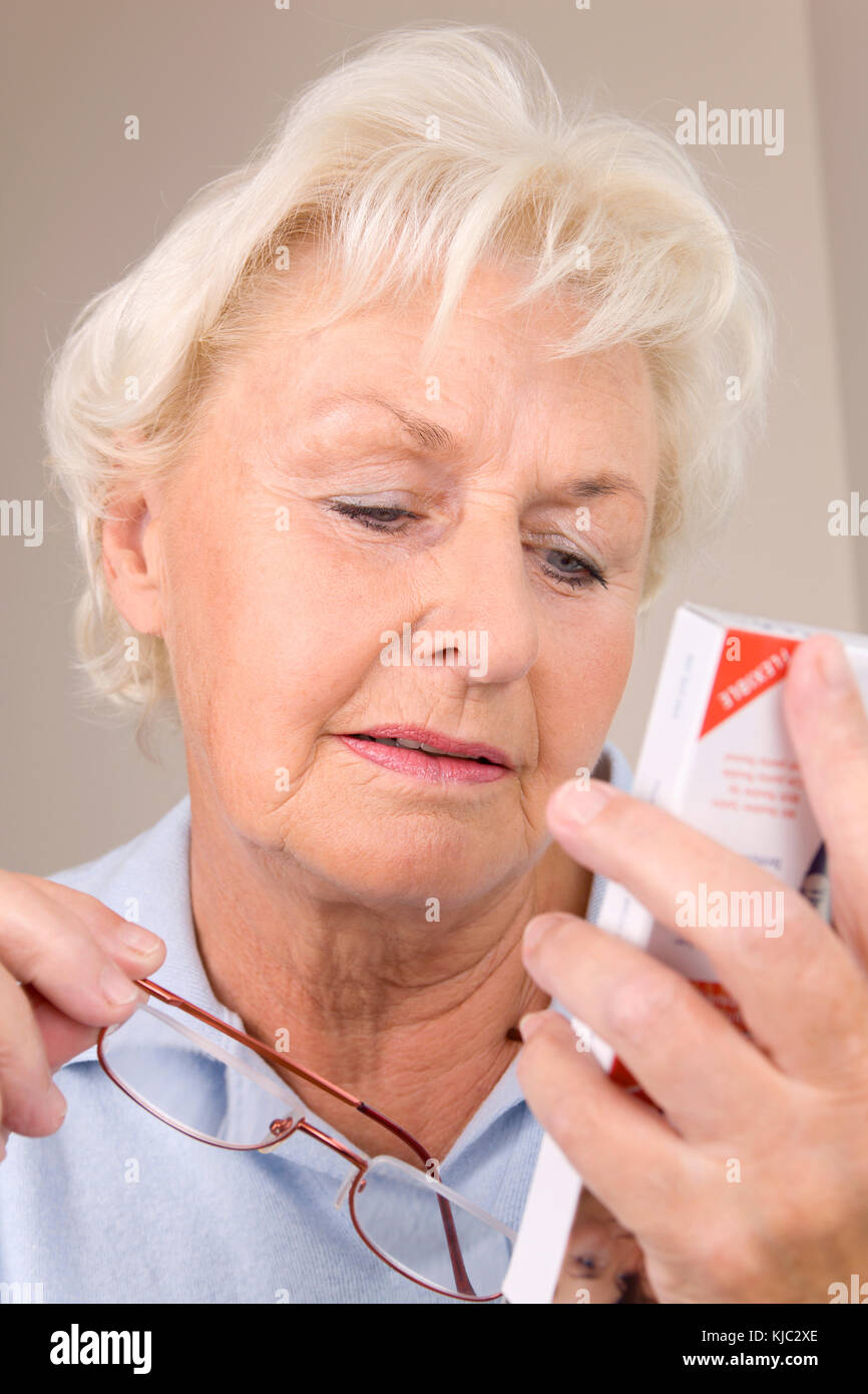 Woman Reading Label on Package Stock Photo - Alamy