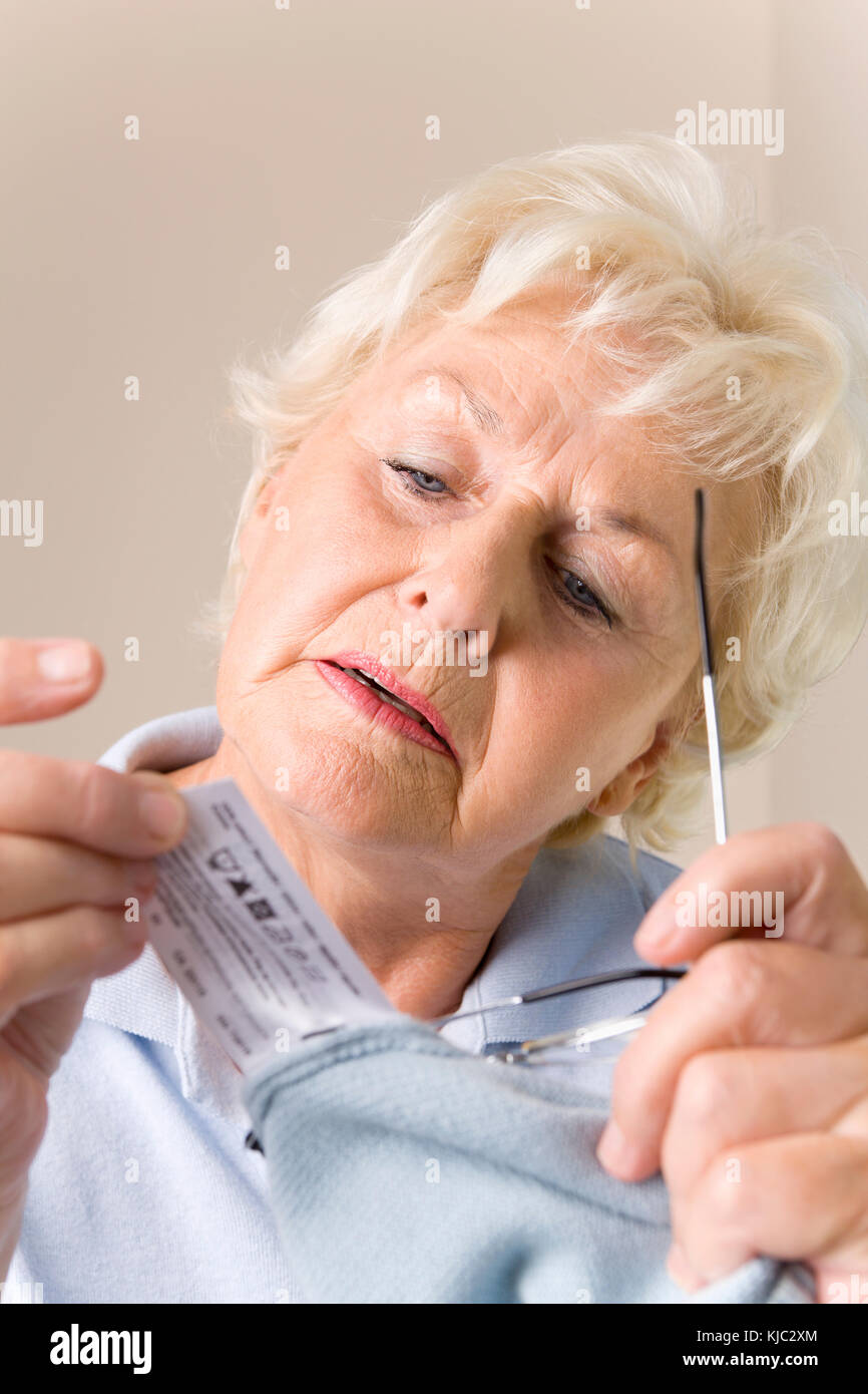 Woman Reading Laundry Instructions Stock Photo - Alamy