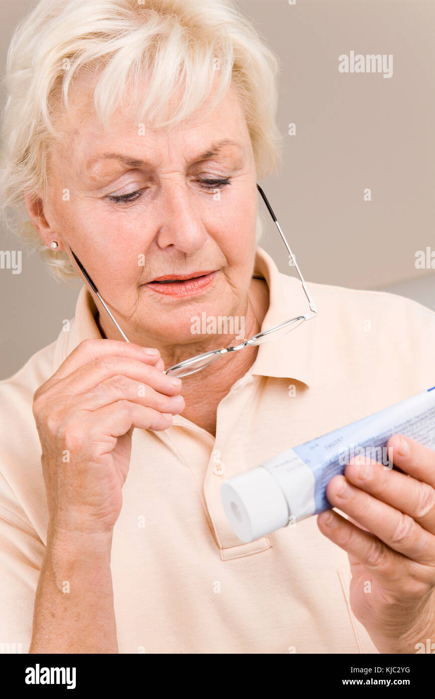 Woman Reading Ingredients on Product Stock Photo - Alamy