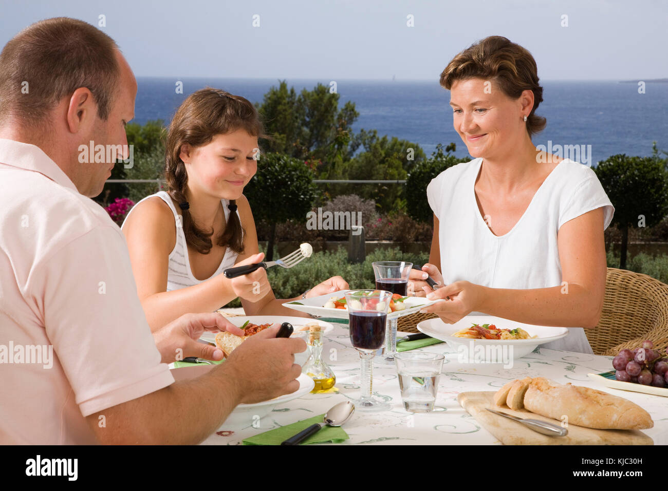 Family Eating on Patio Stock Photo - Alamy