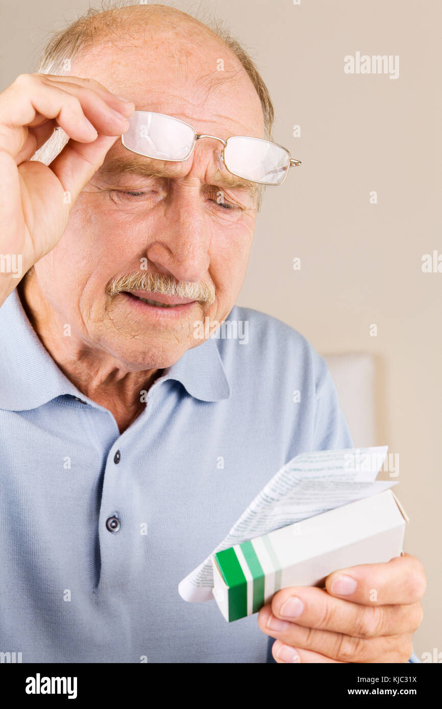 Man Reading Instructions for Medicine Stock Photo - Alamy