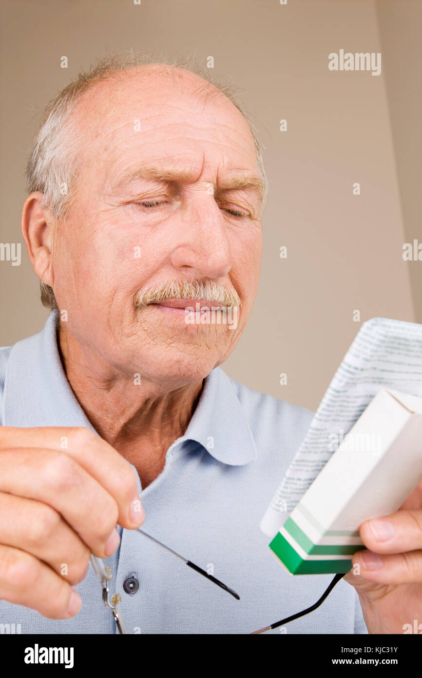 Man Reading Instructions for Medicine Stock Photo - Alamy