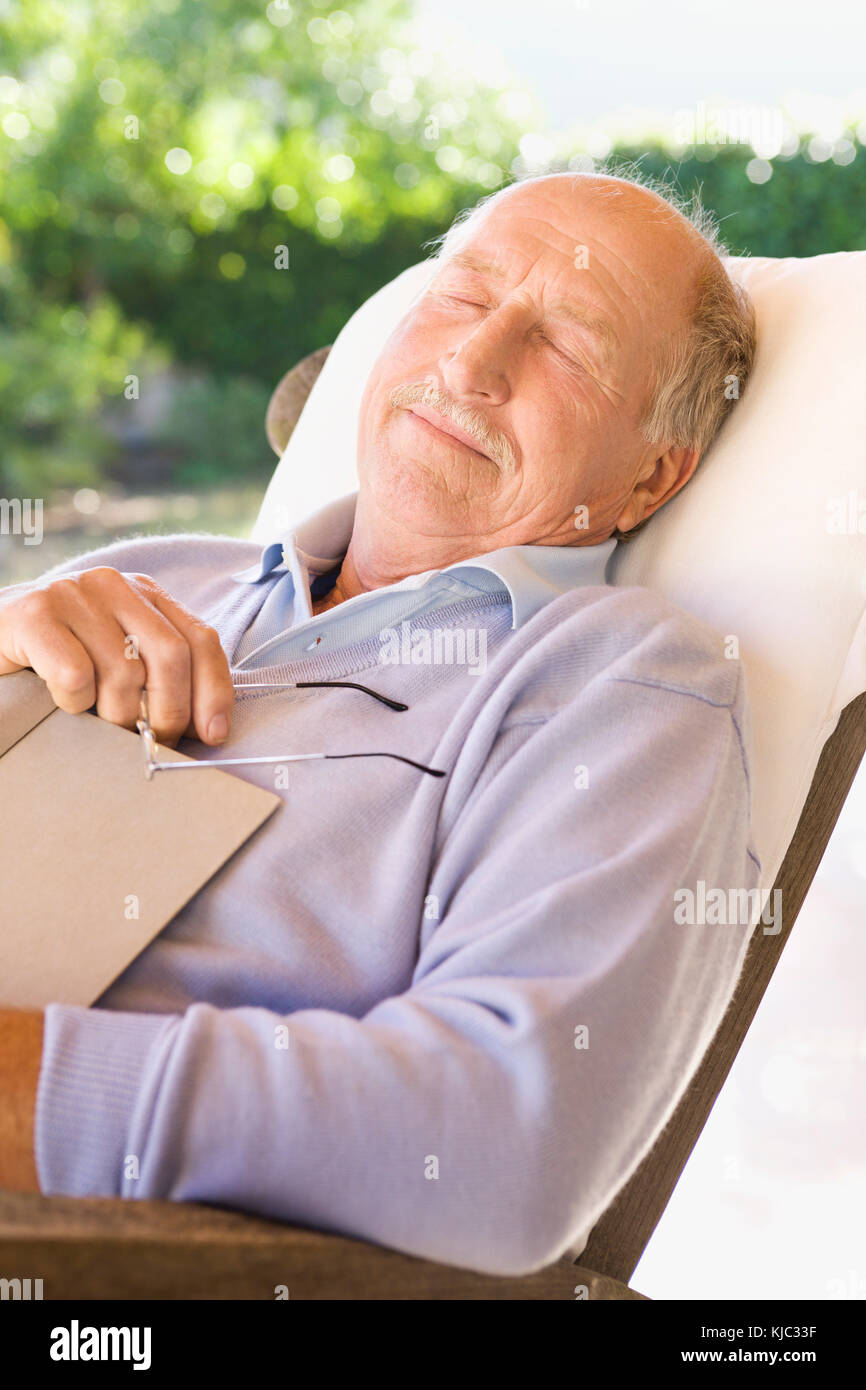 Man Resting after Reading Stock Photo - Alamy