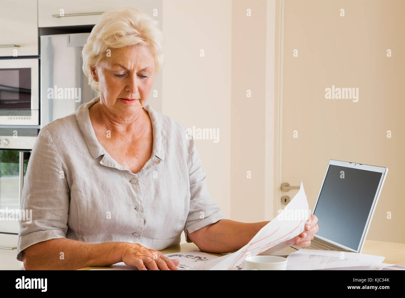 Woman Looking at Paper Stock Photo - Alamy