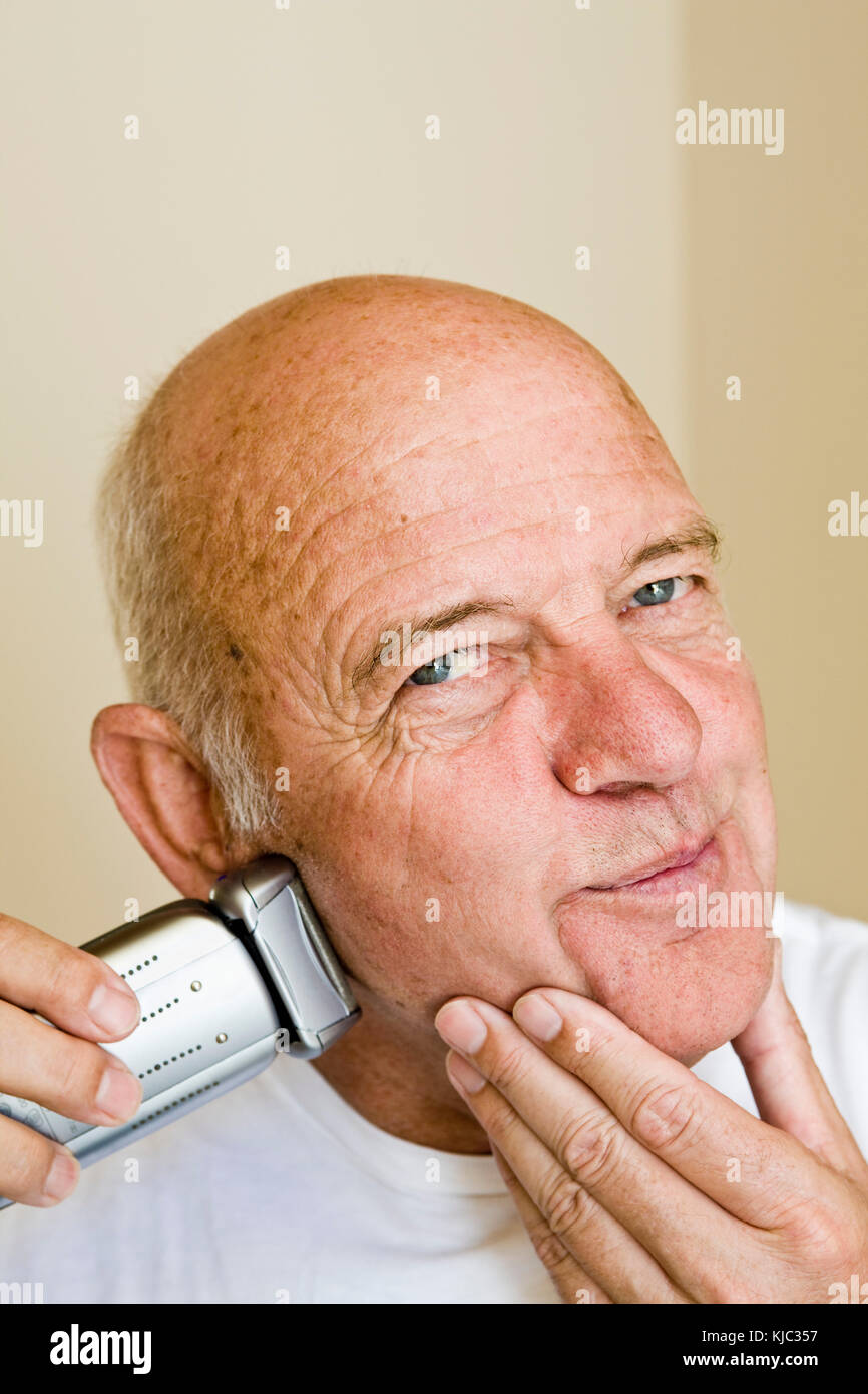 Man Shaving with Electric Razor Stock Photo - Alamy