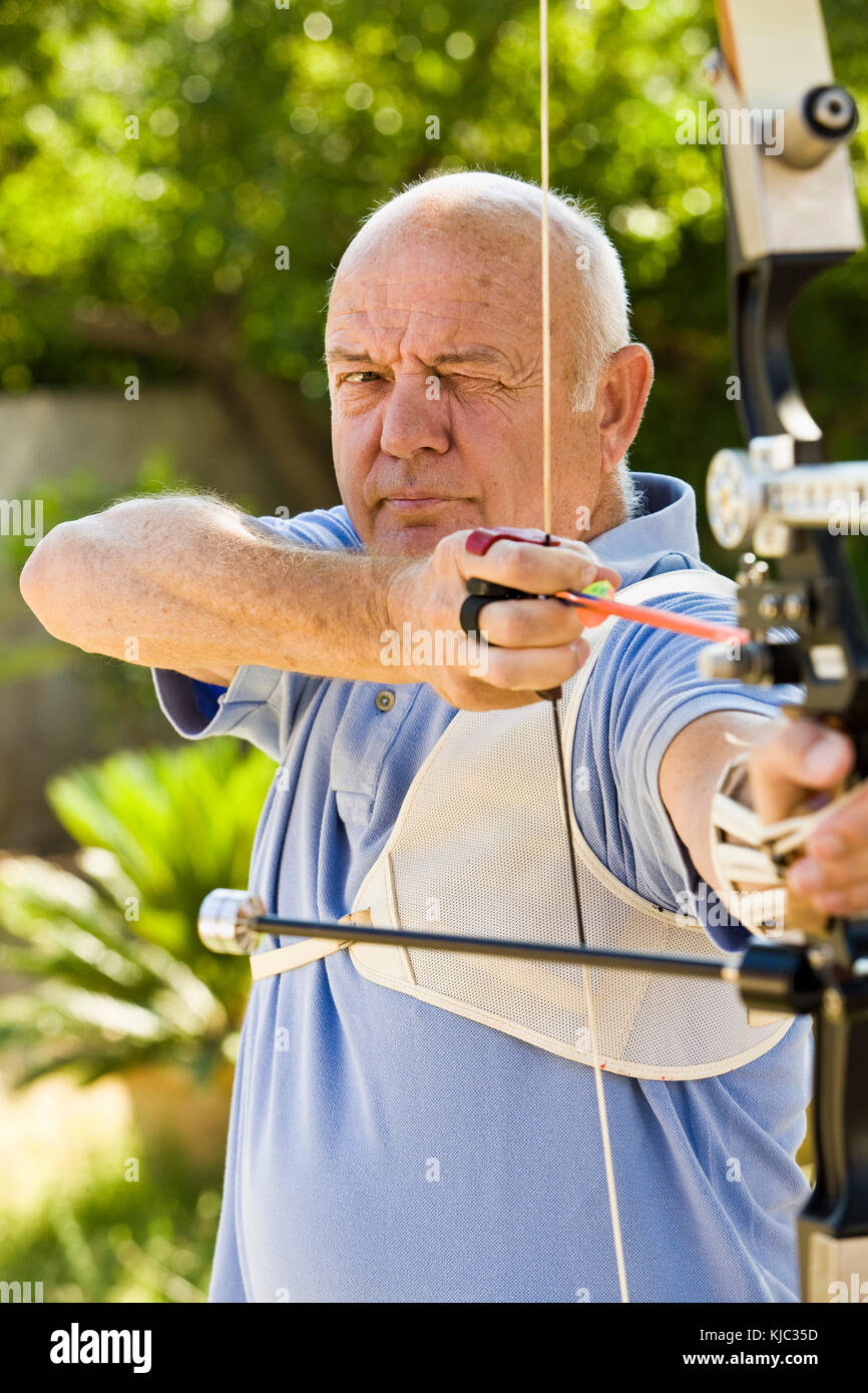 Man Using Bow and Arrow Stock Photo - Alamy