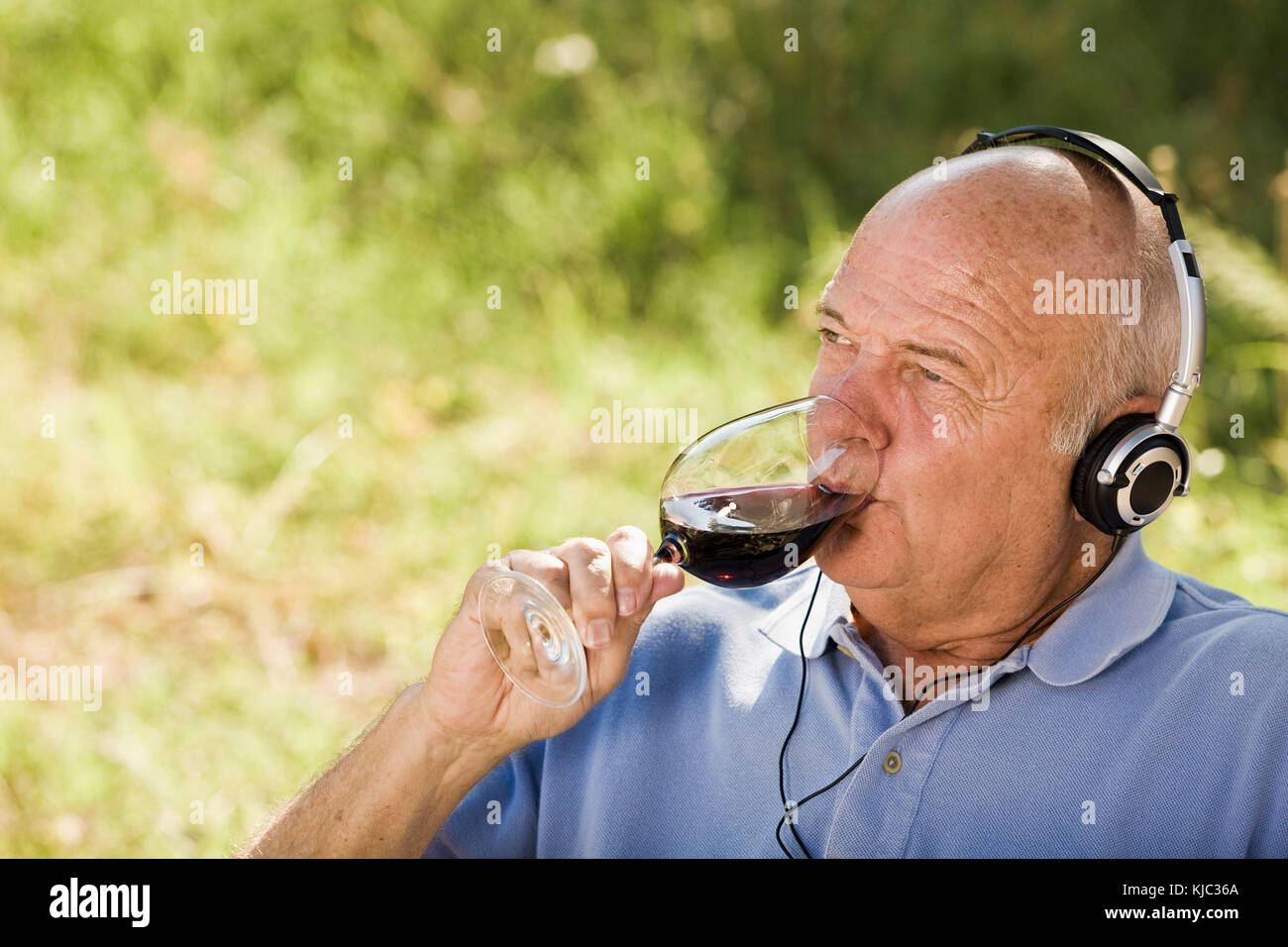 Man Listening to Music and Drinking Red Wine Stock Photo - Alamy