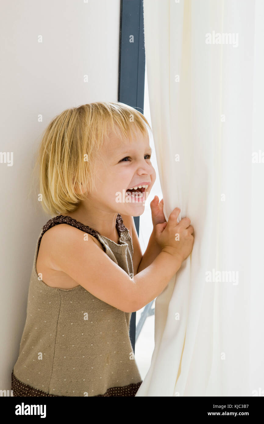 Little Girl Looking Out Window Stock Photo - Alamy