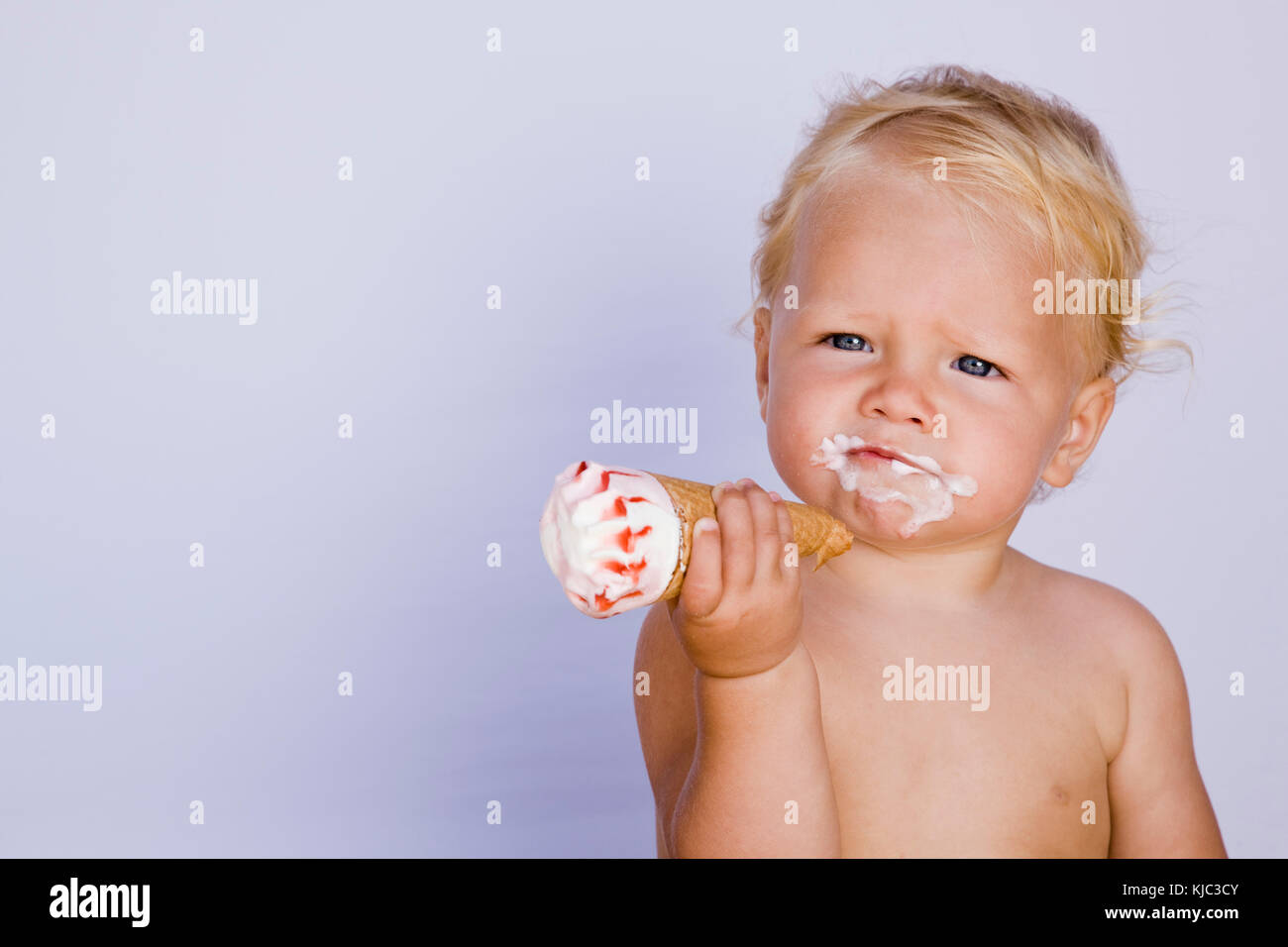 Baby Eating Ice Cream Cone Stock Photo - Alamy