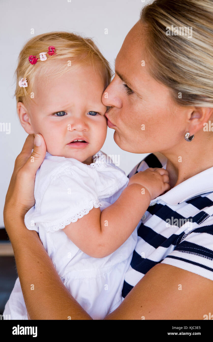 Mother Comforting Baby Girl Stock Photo - Alamy