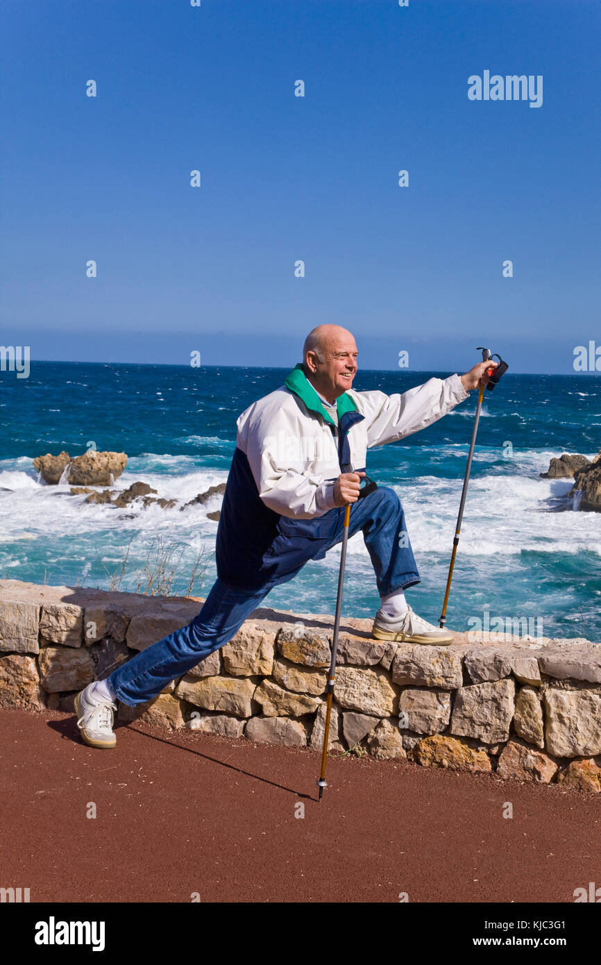 Nordic Walker Stretching by the Sea Stock Photo - Alamy