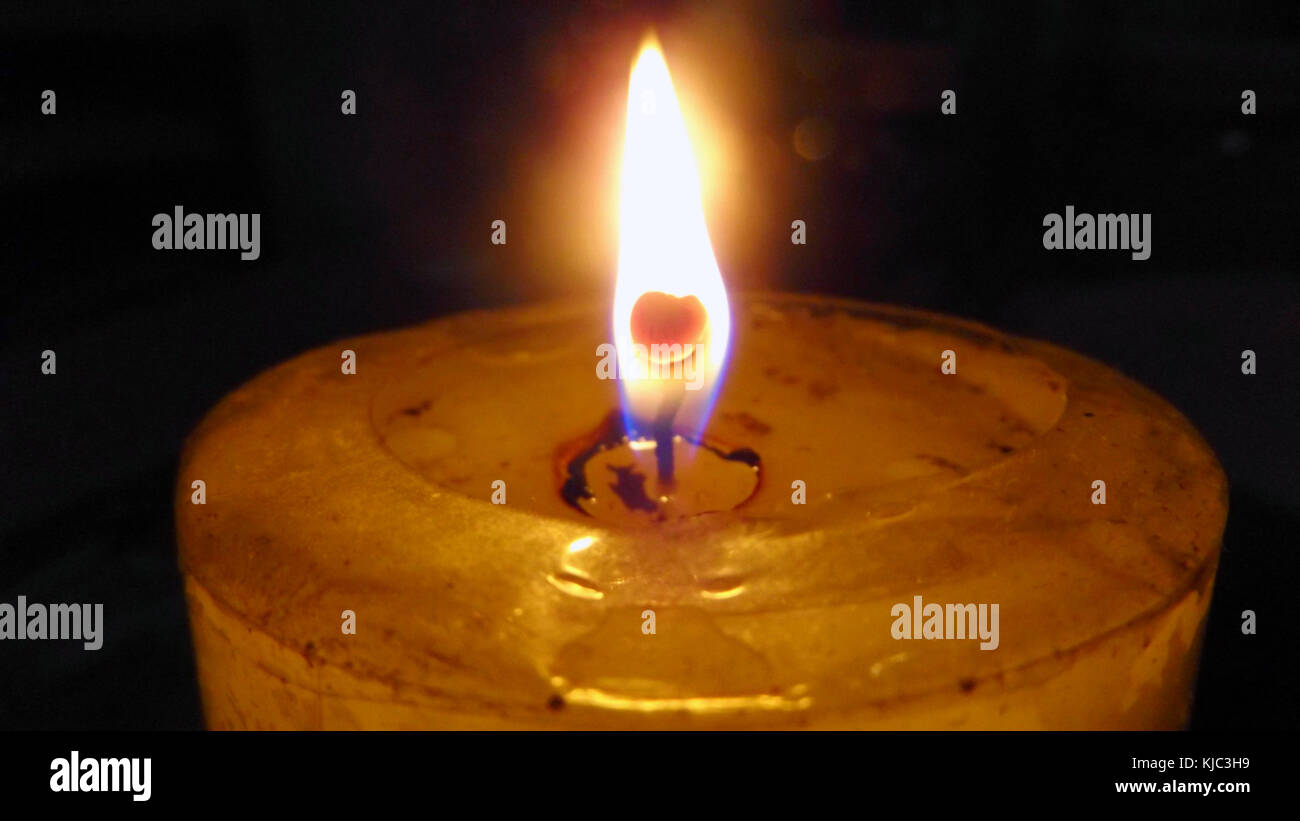 One candle flame at night closeup Stock Photo - Alamy